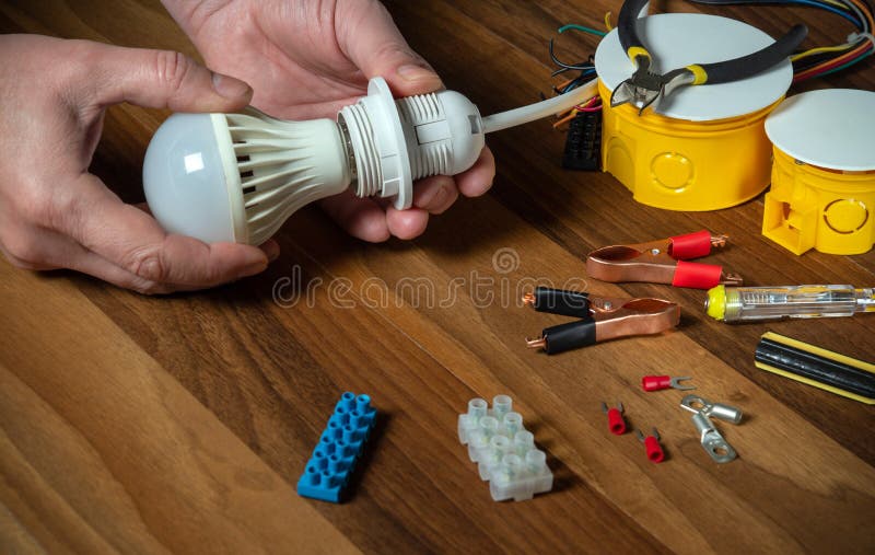 The Master Electrician Turns on Light Bulb. Close Up of a Worker Hand ...