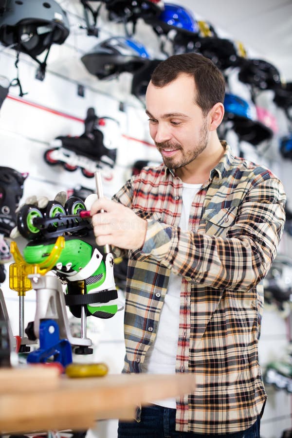 Master Fixing Roller-skates Stock Photo - Image of store, male: 256310386