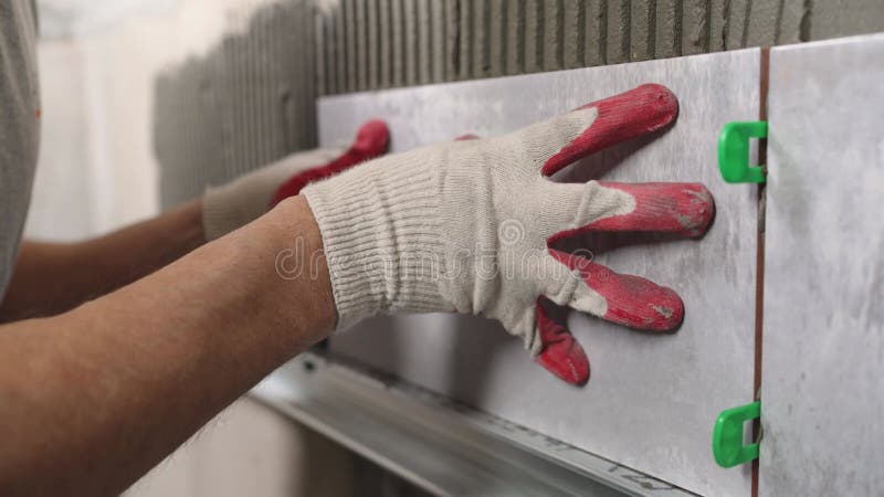 Laying Ceramic Tiles. Professional Constructor Applying Glue before ...
