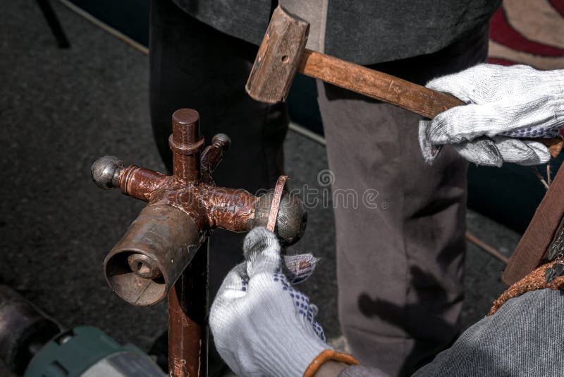 Master with a Hammer Performs Stamping or Engraving of a Decorative ...