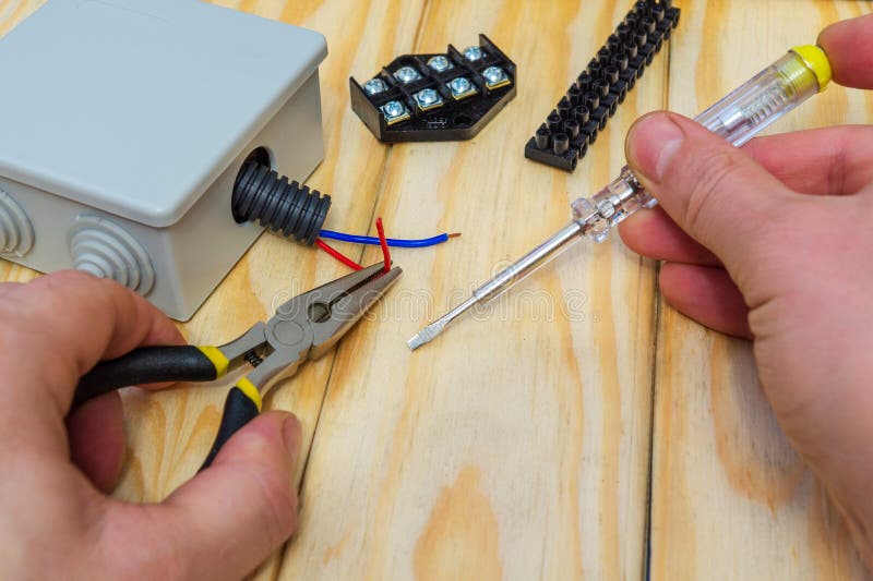 The Master Holds an Electric Tool and Wires To Connect Stock Image ...