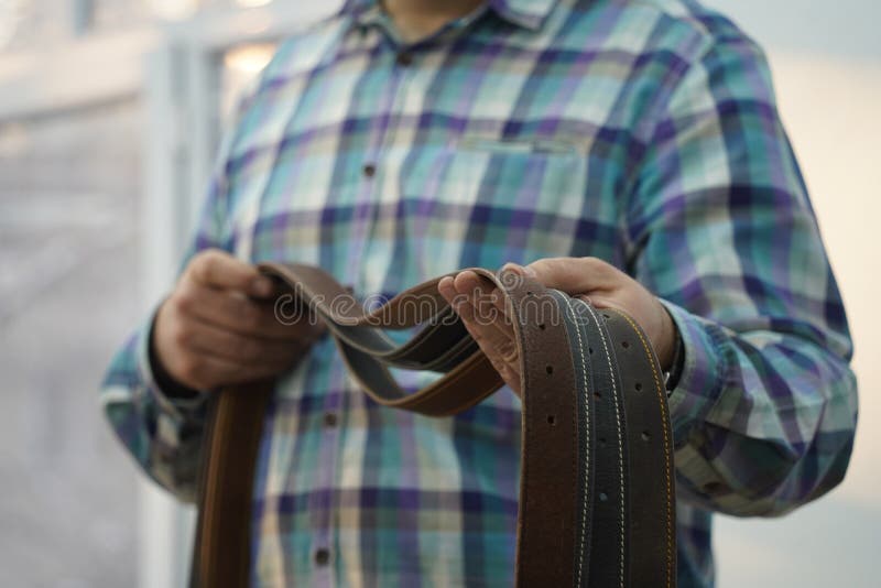 The Master Holds Handmade Leather Belts with Buckles in His Hands Stock ...