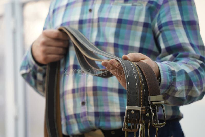 The Master Holds Handmade Leather Belts with Buckles in His Hands Stock ...