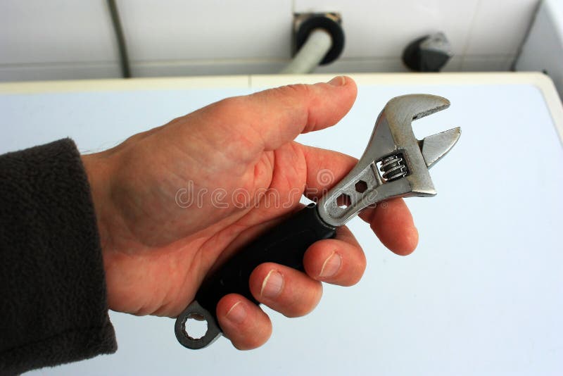 Master Holds a Wrench in His Hands Stock Photo - Image of showing ...