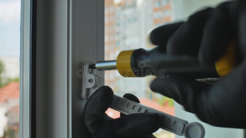 The Master Installs a Window Opening Limiter on a Plastic Window Frame ...