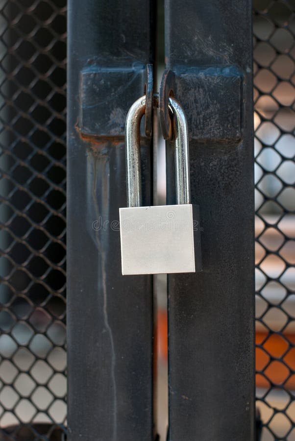 Master Key Silver Lock on the Black Iron Door. Stock Photo - Image of ...