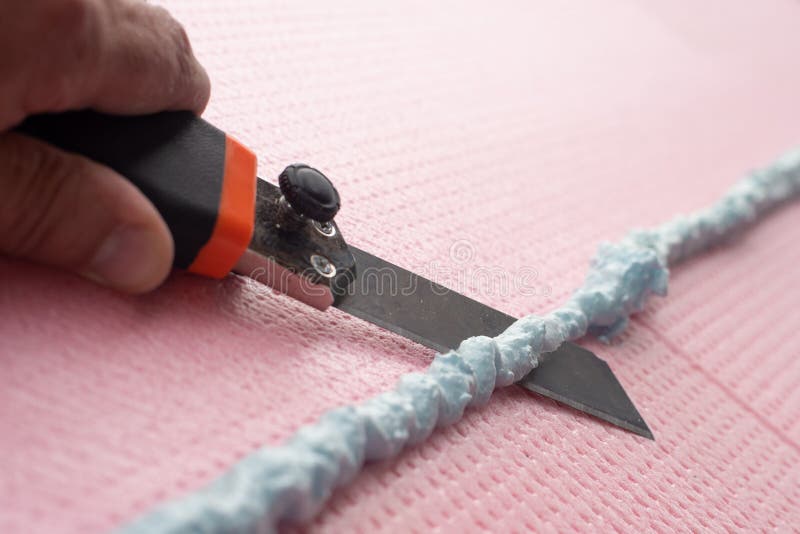 The Master with a Knife Cuts Off Excess Construction Foam Stock Image ...