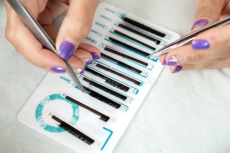 Master Lash Maker is Holding One False Eyelash by Tweezers in Hand ...