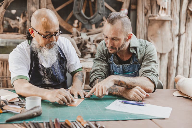 Master of Leather Tailor Teaching and Training Young Man for Making ...