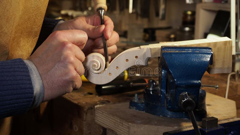 Skilled Luthier Meticulously Carves a Violin Scroll by Hand, Showcasing ...