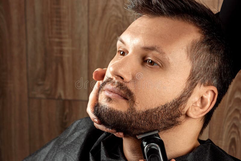 The Master Makes a Beard Haircut To the Client with an Electric Machine ...