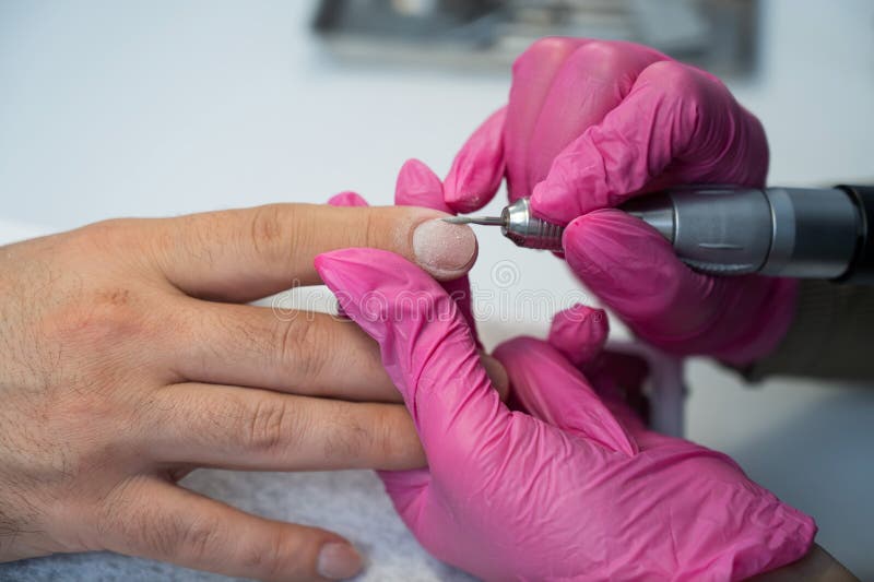 The Master Makes a Hardware Manicure To a Male Client. Stock Image ...
