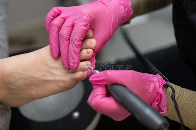 The Master Makes Hardware Pedicures To the Client. Cuticle Treatment ...