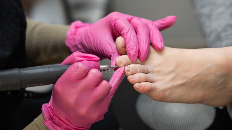 The Master Makes Hardware Pedicures To the Client. Cuticle Treatment ...
