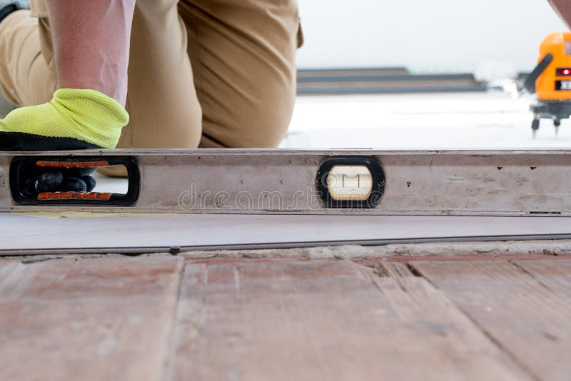 The Master Measures the Level of the Floor Surface. Stock Image - Image ...