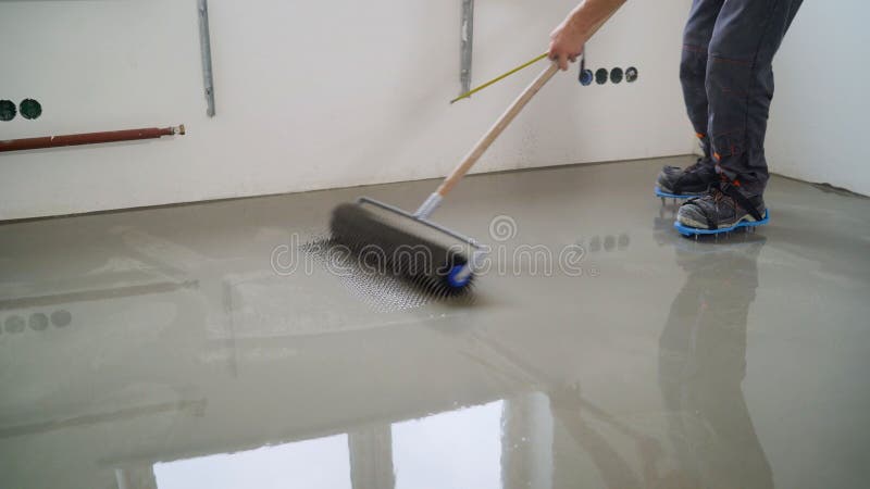 Master with a Needle Roller for a New Floor. Concrete Floor. Needle ...