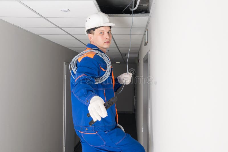 The Master of the Office Internet Installation Holds Wires and Tools in ...