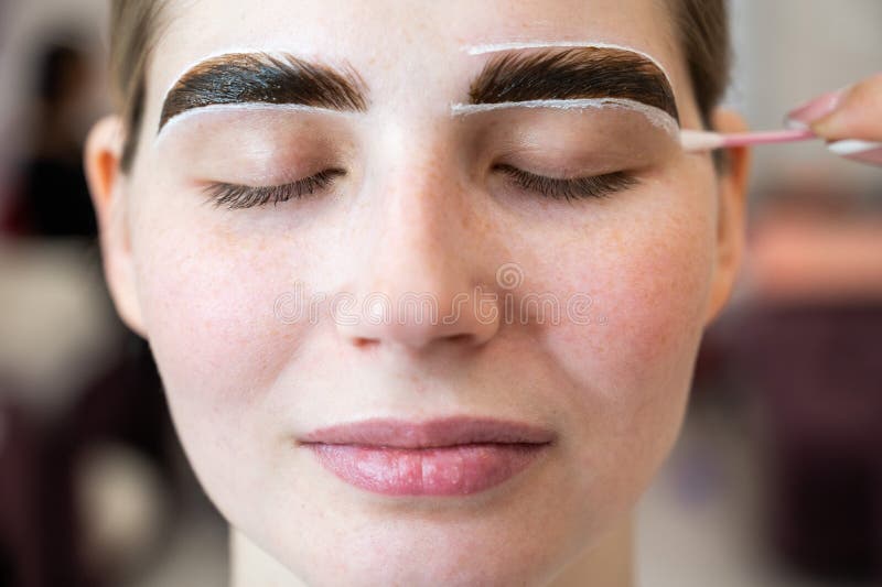 The Master Paints the Eyebrows of a Woman. Stock Image - Image of care ...
