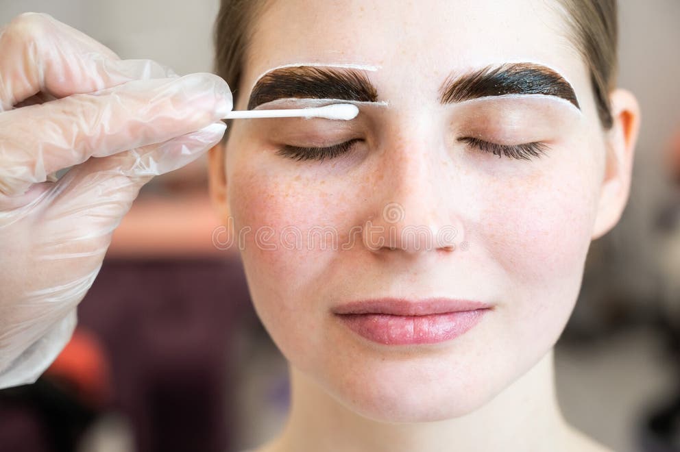 The Master Paints the Eyebrows of a Woman. Stock Photo - Image of ...