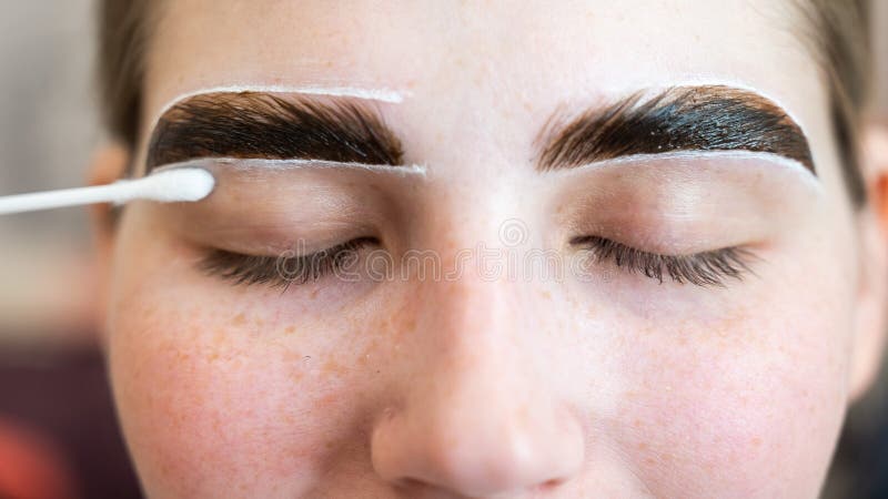 The Master Paints the Eyebrows of a Woman. Stock Image - Image of ...