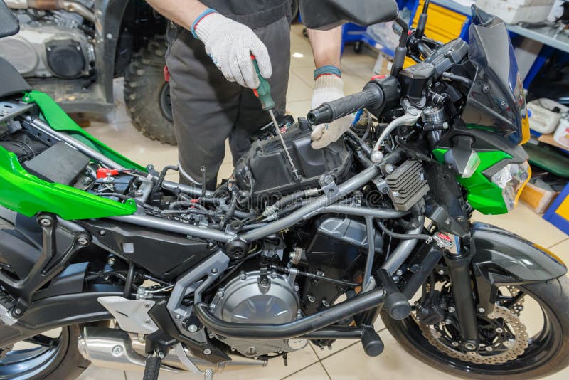 The Master Performs Maintenance on the Motorcycle Stock Photo - Image ...
