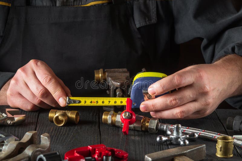 Master Plumber Measures the Distance Using a Tape Measure. Working ...