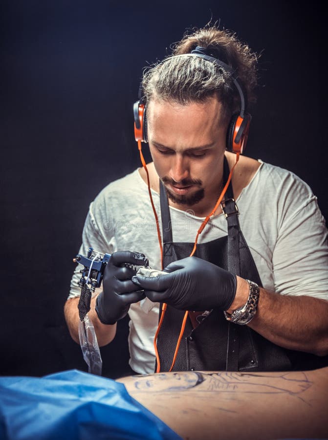 Master of the Art of Tattooing Demonstrates the Process of Getting ...