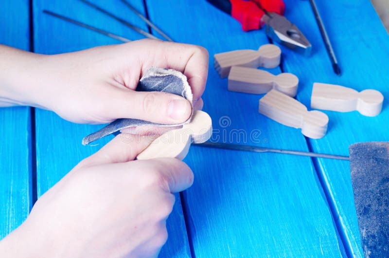 The Master Processes the Wood with His Hands. Working Hands on a Blue ...