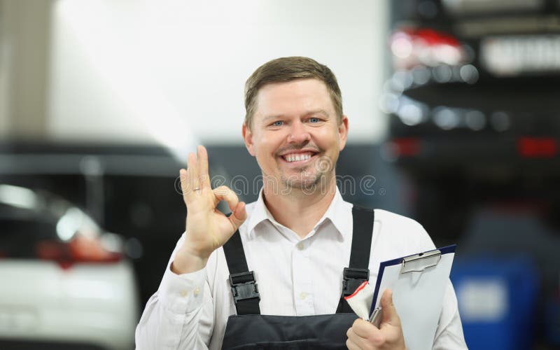 Master Repairman Holding Documents and Showing Ok Gesture in Workshop ...