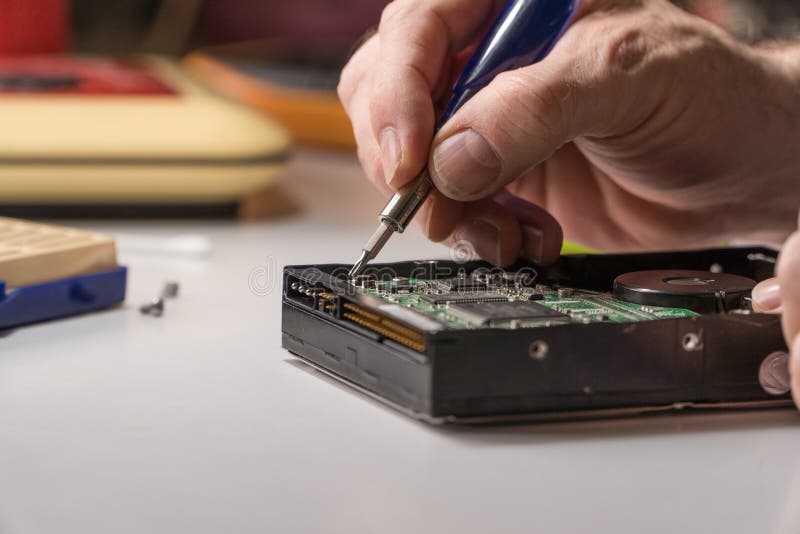Master repairs chip stock image. Image of motherboard - 144463411