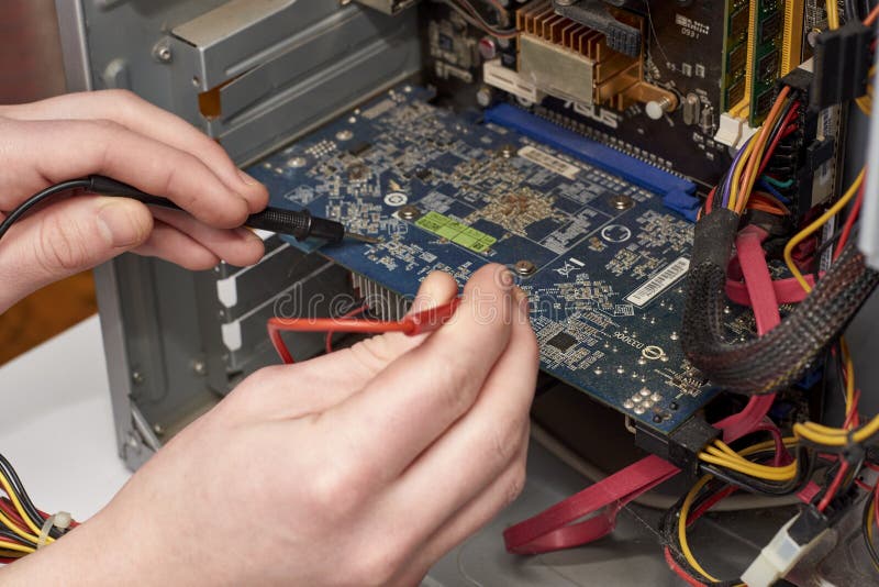 The Master Repairs the Computer Measures the Voltage on the Board with ...
