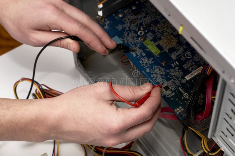 The Master Repairs the Computer Measures the Voltage on the Board with ...