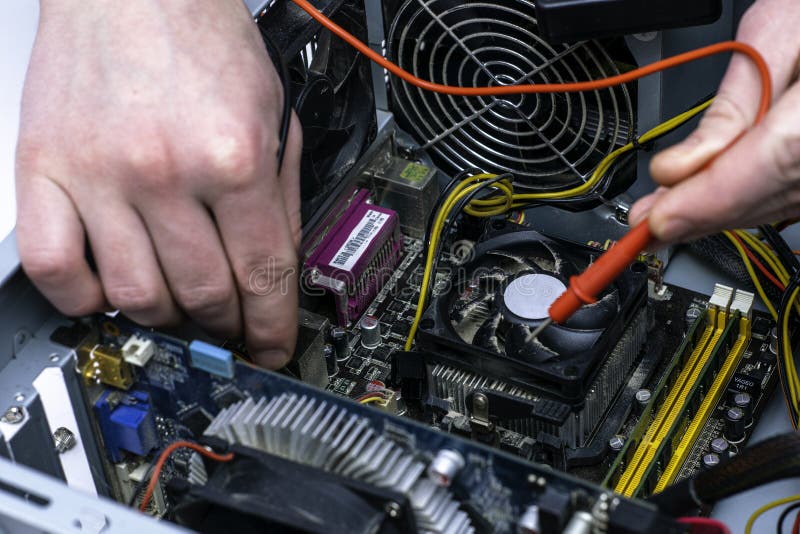 The Master Repairs the Old Computer Checks the Chips with a Multimeter ...