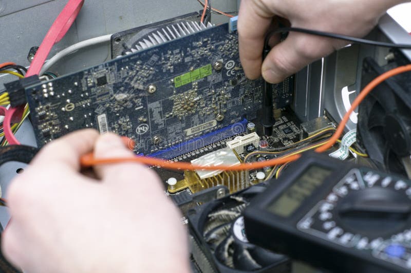 The Master Repairs the Old Computer Checks the Chips with a Multimeter ...