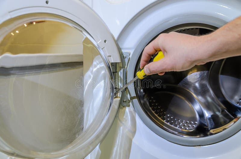 Master Repairs Washing Machine with a Screwdriver Stock Image - Image ...