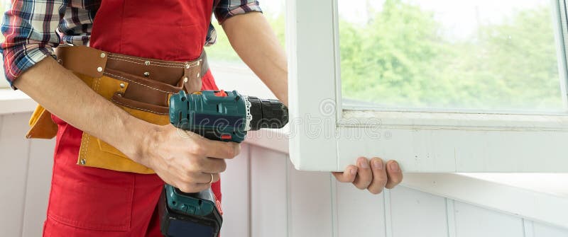 Master with a Screwdriver Sets Fittings on the Window Stock Image ...