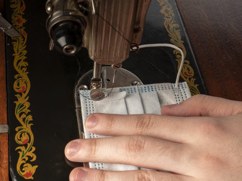 The Master Sews a Medical Mask on a Sewing Machine Stock Image - Image ...
