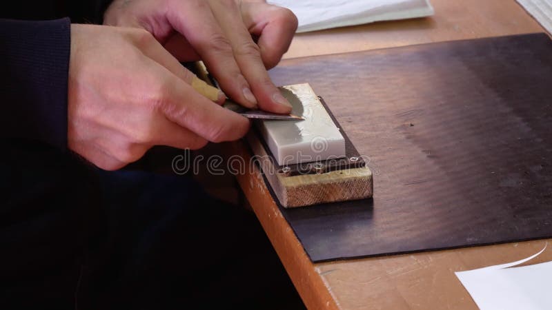 The Master Sharpens a Chisel with a Knife. Sharpening a Wood Carving ...