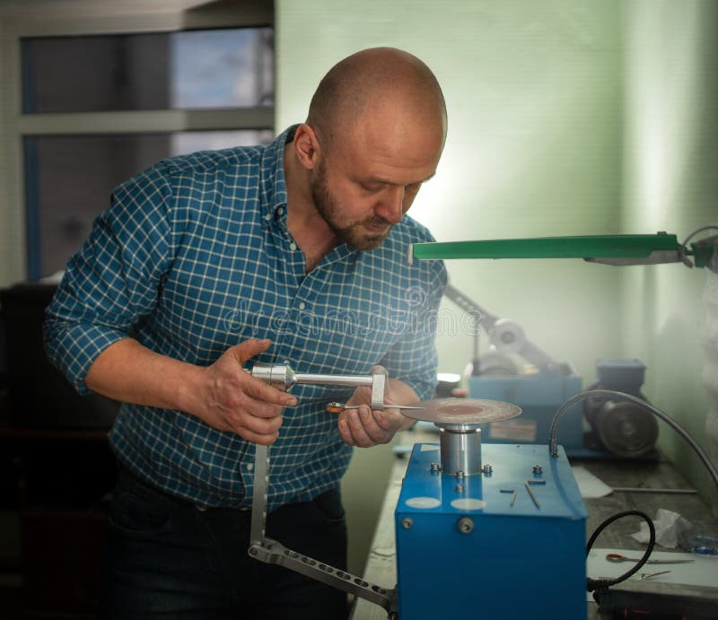 Master Sharpens Scissors on Special Equipment for Sharpening Tool Stock ...