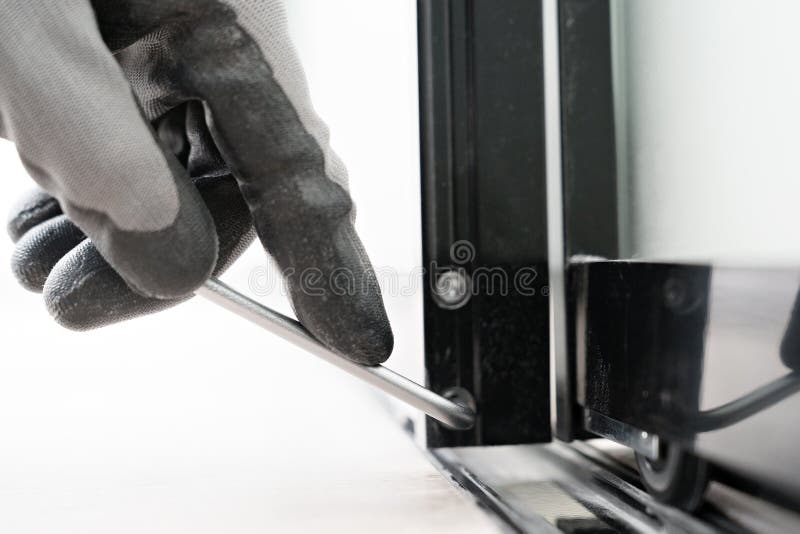 Master with Special Screwdriver Adjusts Sliding Doors of Wardrobe Stock ...