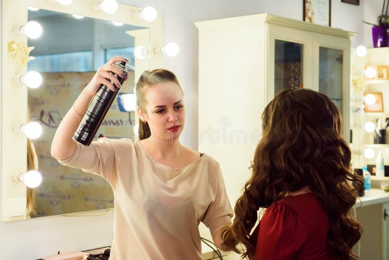 Master Stylist Makes Model Hairstyle Using Spray Lacquer Fixing. Stock ...