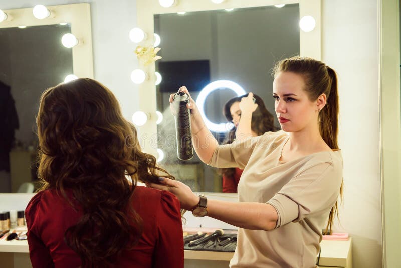 Master Stylist Makes Model Hairstyle Using Spray Lacquer Fixing. Stock ...