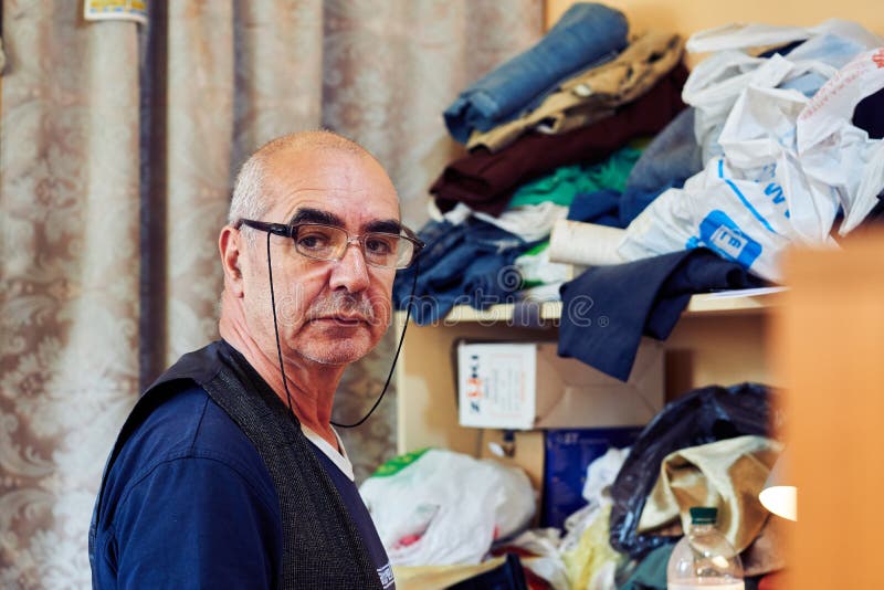 Master Tailor in Glasses in a Workshop for Tailoring and Repairing ...