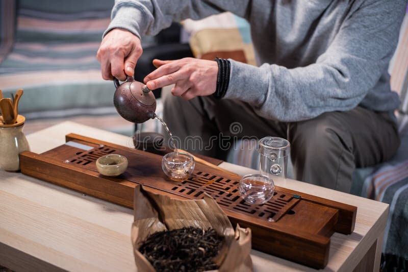 The Master of Tea Ceremonies Pours Amber Tea in a Thin Stream into ...