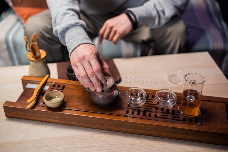 The Master of Tea Ceremonies Pours Amber Tea in a Thin Stream into ...