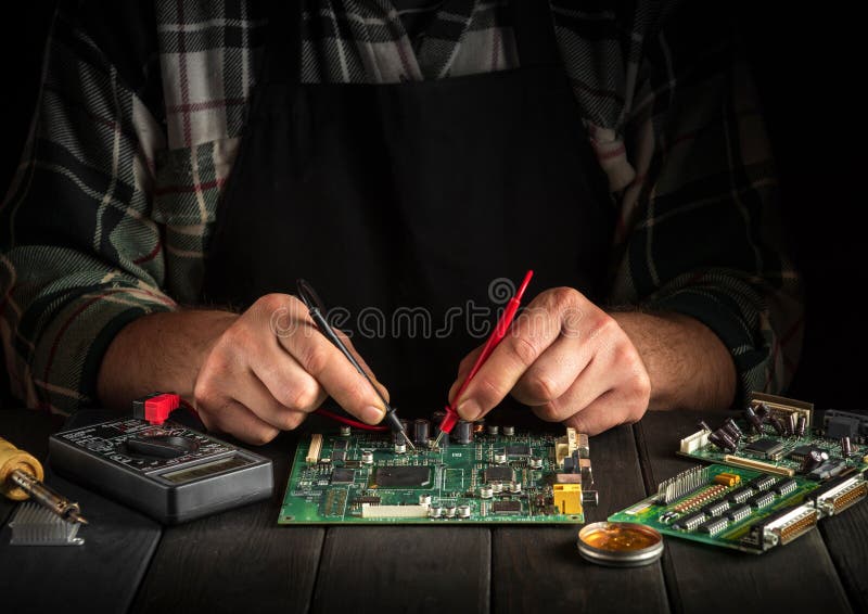 The Master Tester Checks the Electronic Board in the Workshop. Computer ...