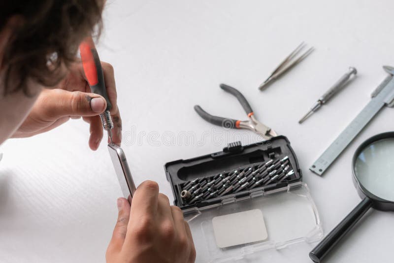 Master with Tools Repair the Broken Smartphone in the Workshops Stock ...