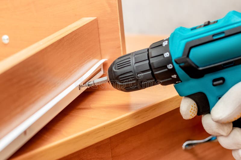 The Master Uses a Cordless Screwdriver To Repair the Drawer from the ...