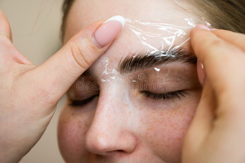 The Master Uses a Plastic Film during Lamination of the Eyebrows. Stock ...