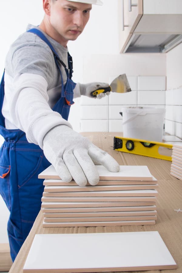 Master Wall Decorator, Takes a Stack of White Tiles for Laying Stock ...